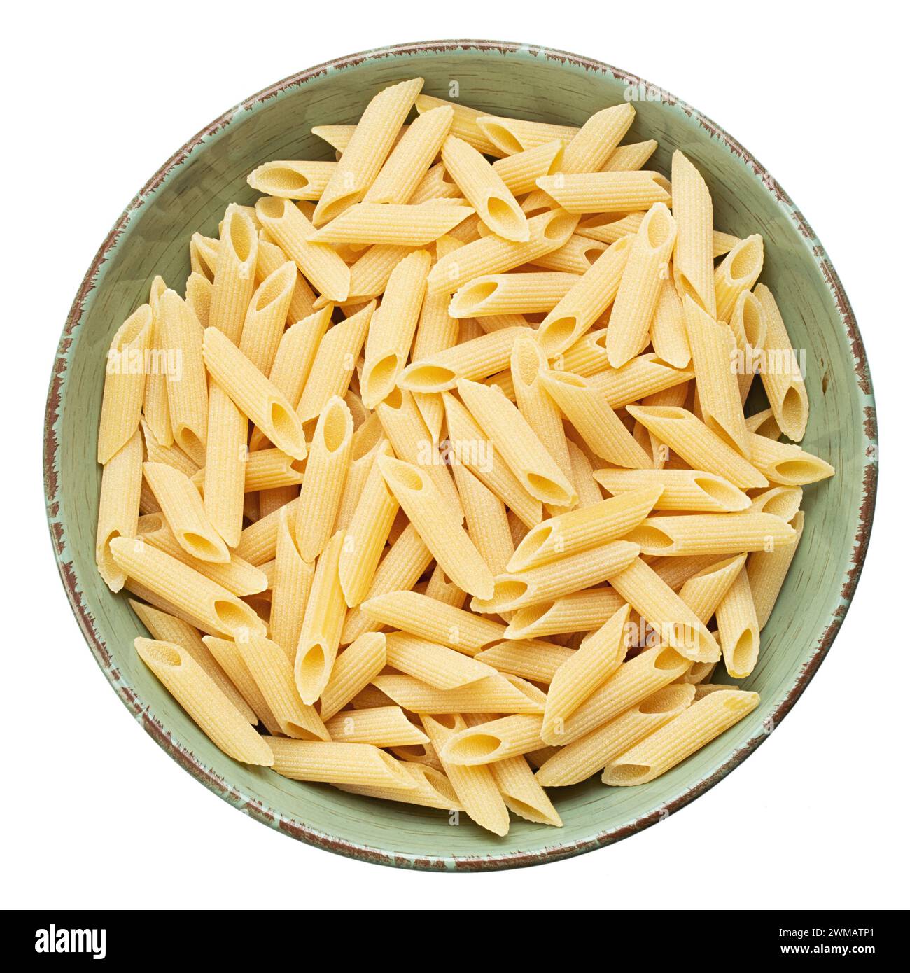 Pennette rigate. Raw pasta in a plate isolated on white background. Top ...