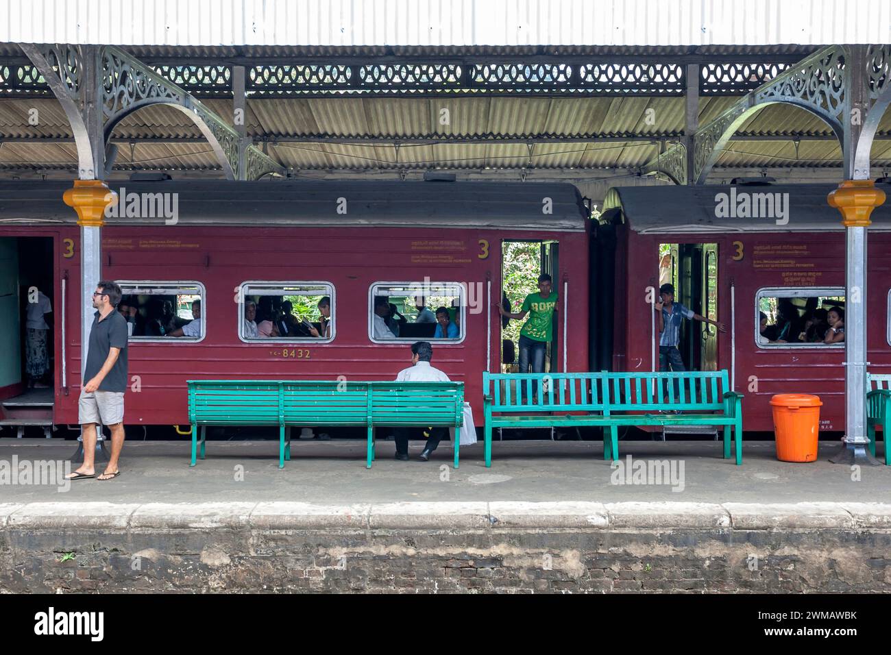 KANDY, SRI LANKA - JULY 30, 2012 : Passengers aboard a train wait to ...