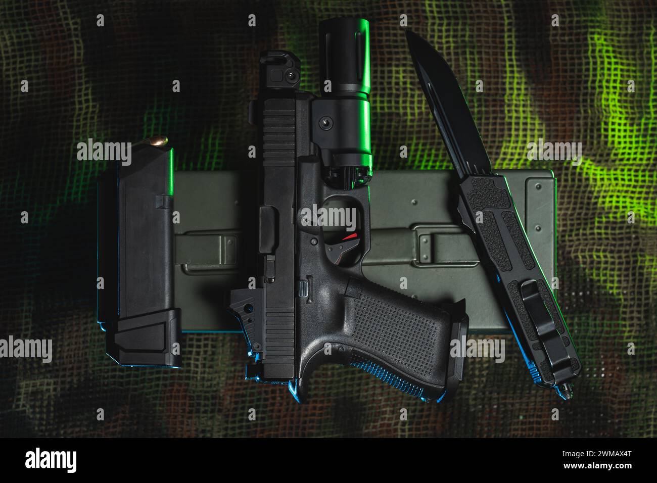 Tactical weapon, pistol with red dot and flashlight, folding knife and ...