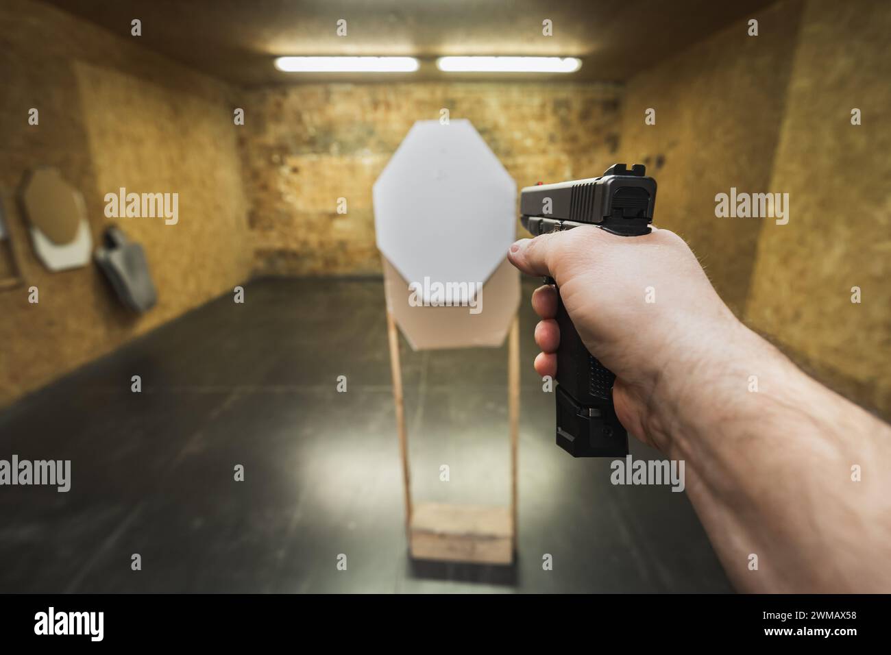 Shooting a pistol with one hand at a shooting range at an ipsc target ...
