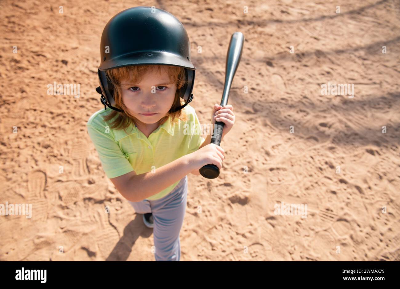 Kid holding a baseball bat. Pitcher child about to throw in youth ...