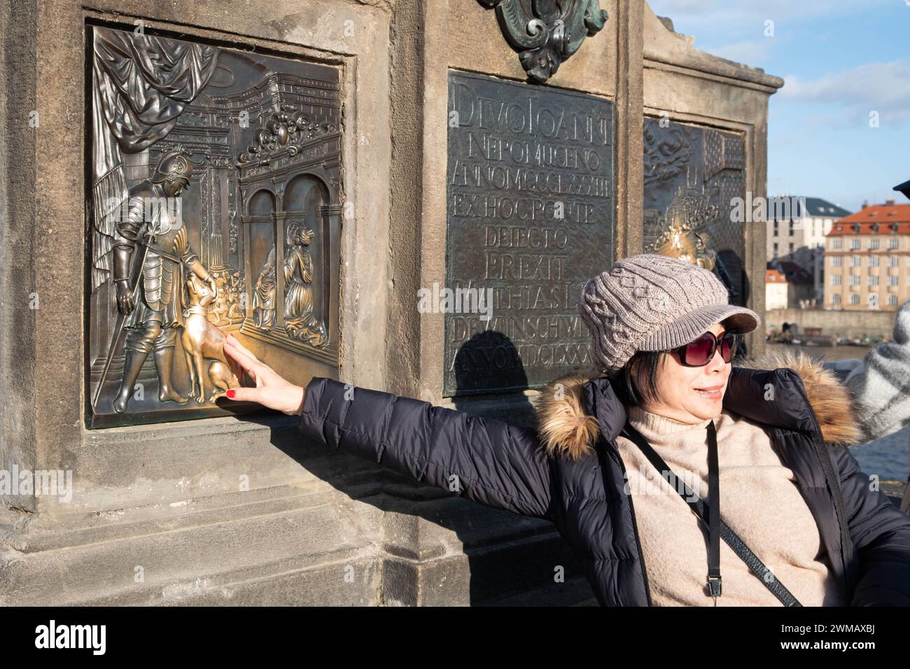 Prague, Czech Republic - January, 2024: Tourist touching the relief at ...
