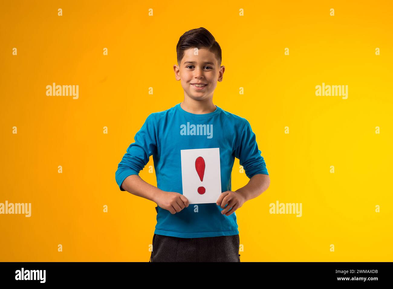 Portrait of kid boy holding exclamation point card. Education and ...
