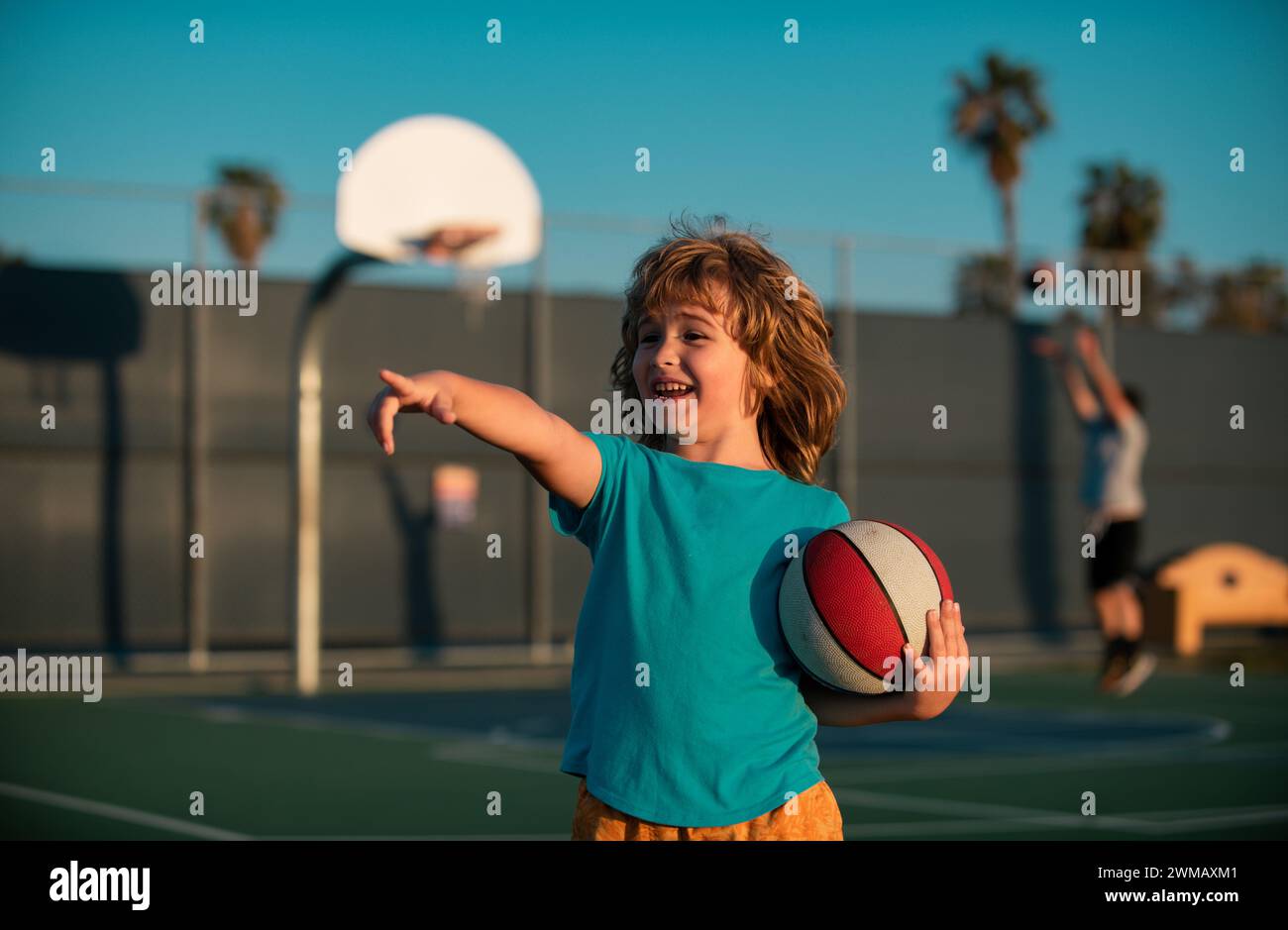 Basketball game. Kid training with basket ball on basketball court ...
