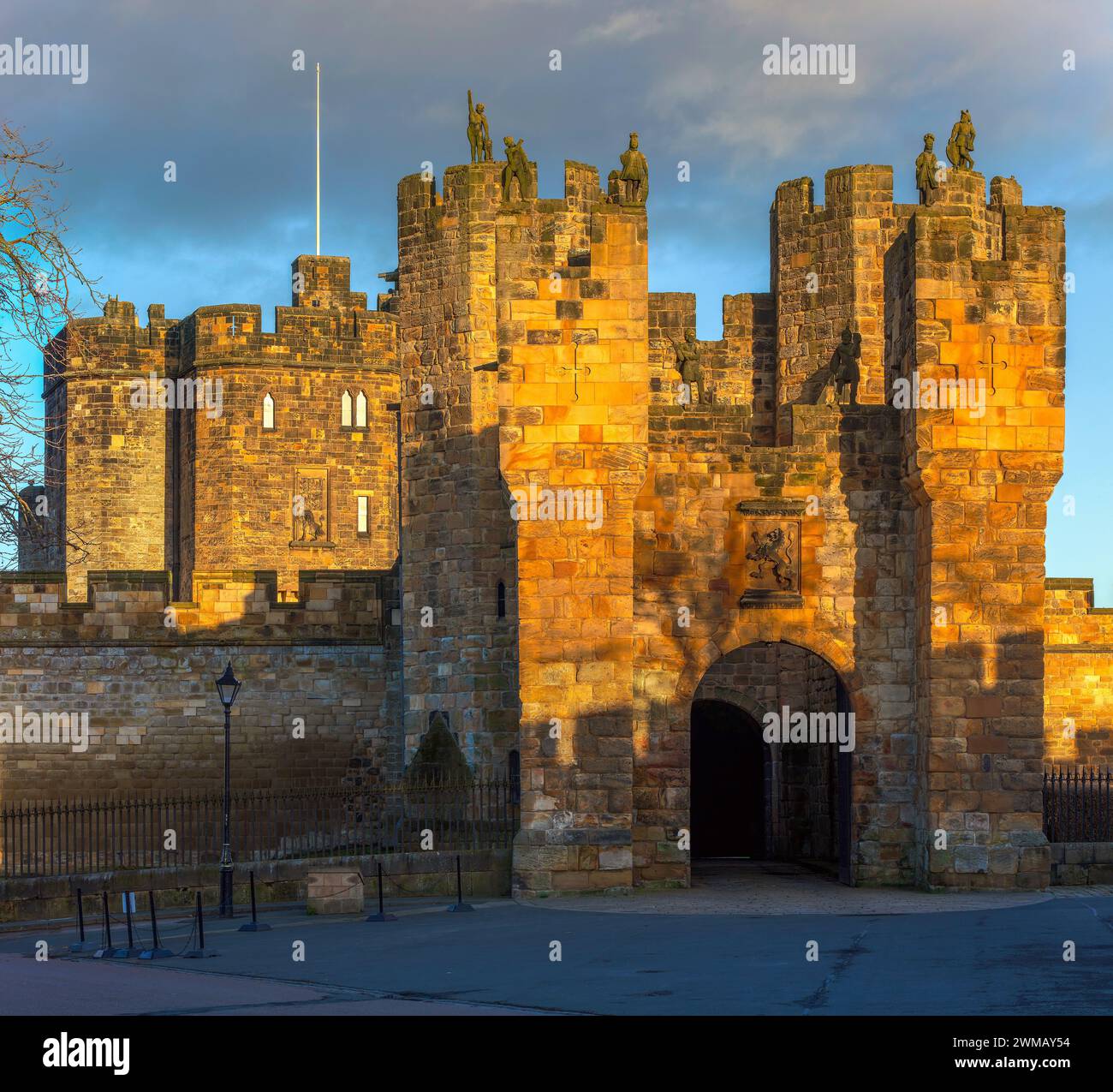 A view near sunset of the Barbican and Gatehouse at Alnwick Castle in ...