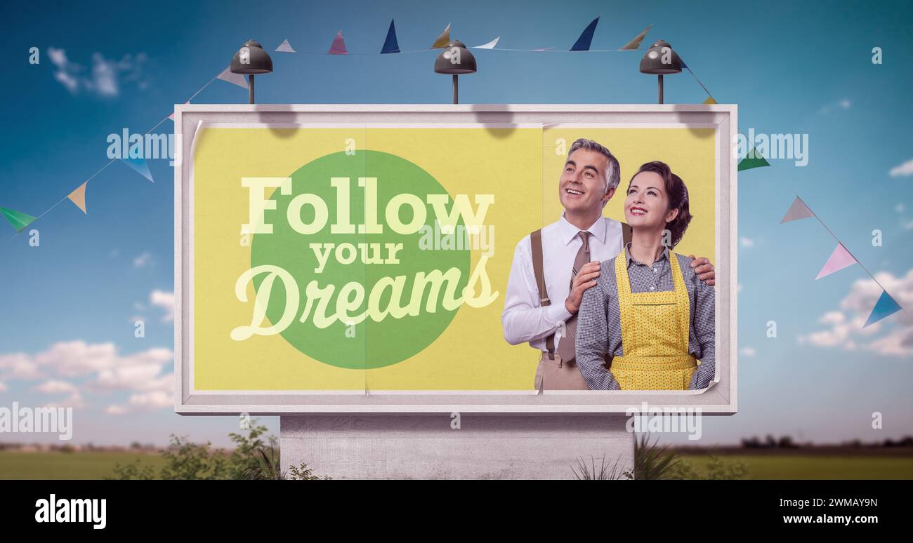 Confident vintage style couple looking away on billboard advertisement ...