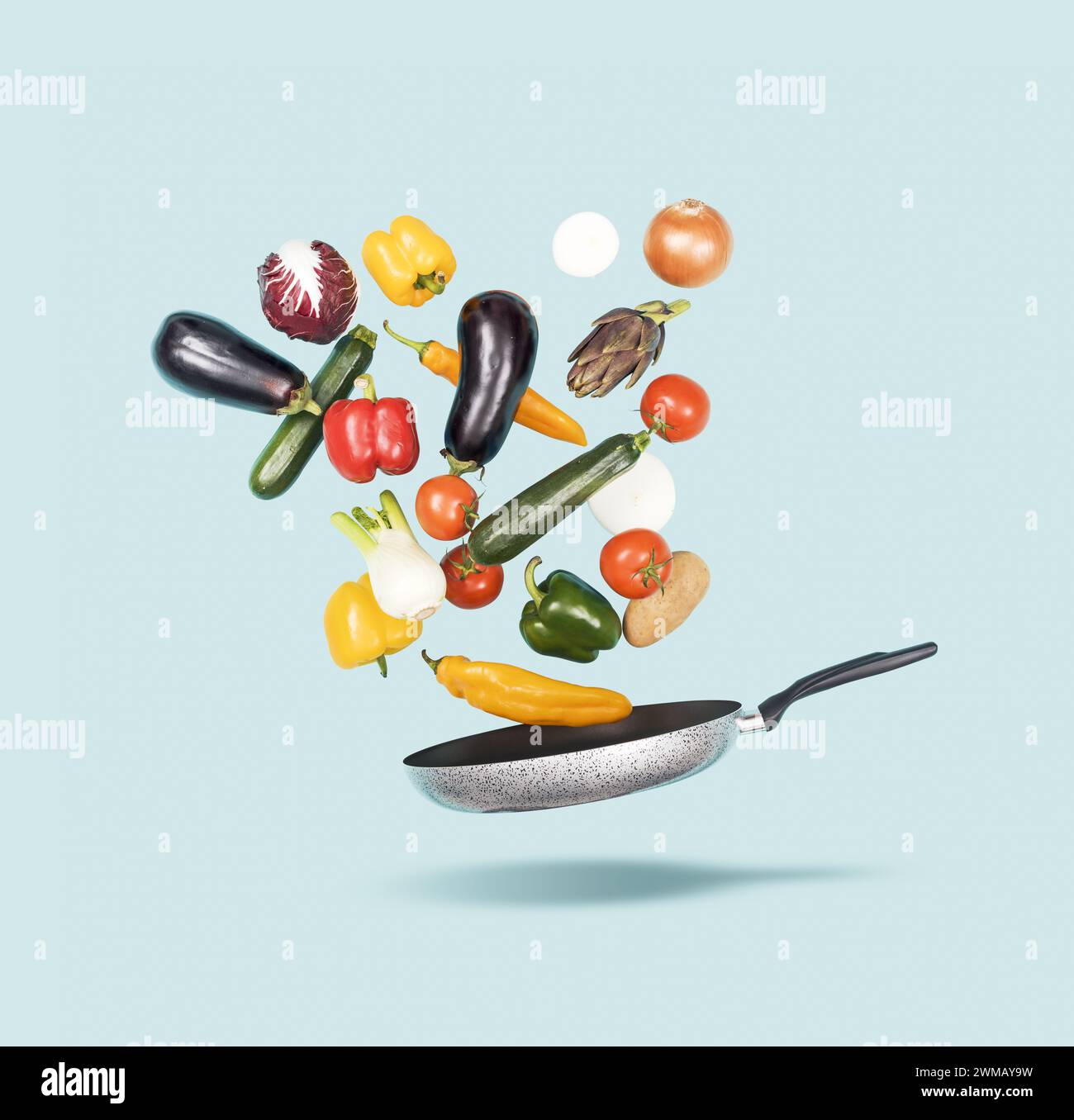 Fresh healthy vegetables falling in a pan, healthy food and cooking ...