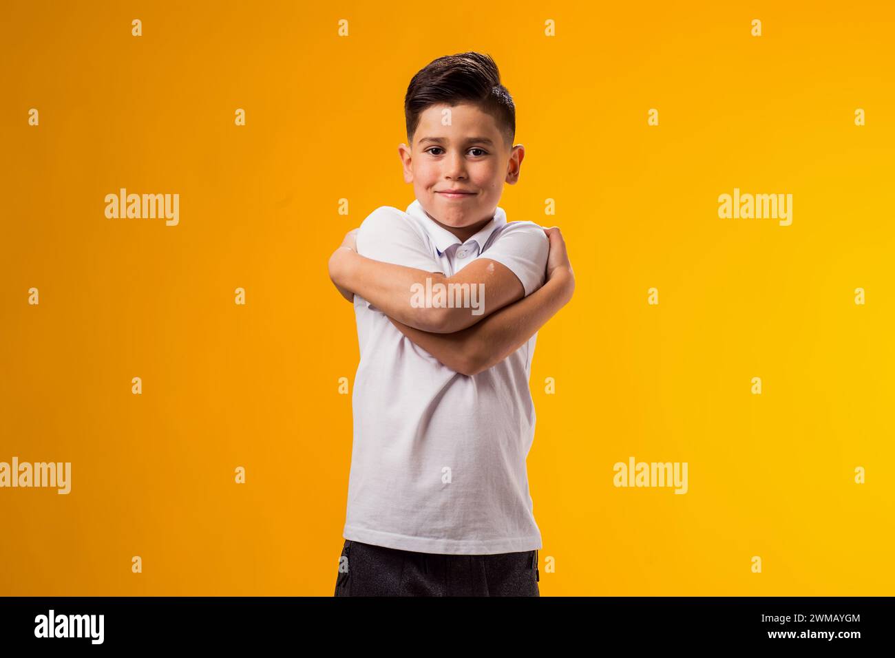 ortrait of kid boy hugging oneself happy and positive, smiling ...