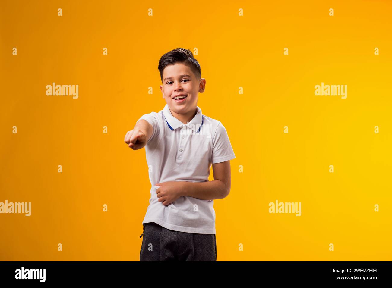 Portrait of kid boy mocking and teasing at someone showing finger at ...