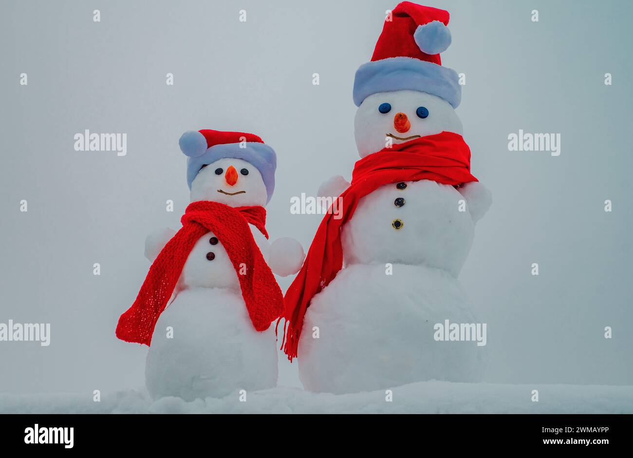 Snow man. Two snowman on snow background Stock Photo - Alamy