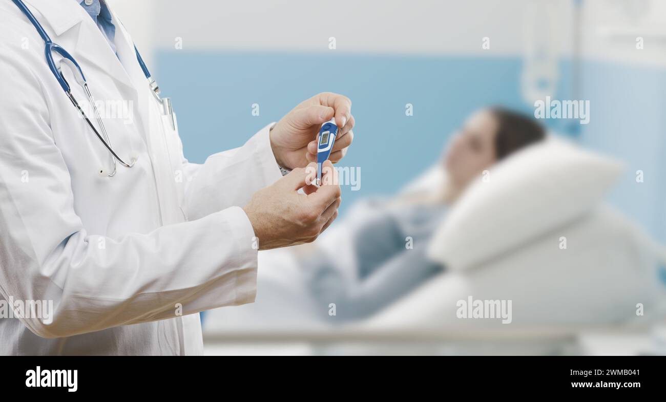 Professional doctor holding a thermometer, he is taking a patient's ...