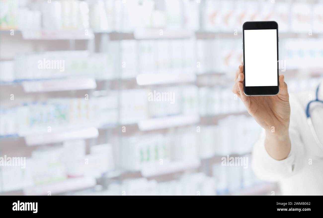 Pharmacist showing a smartphone with blank screen at the pharmacy ...