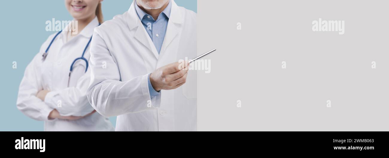 Doctors showing a big empty poster and giving medical advice, blank ...