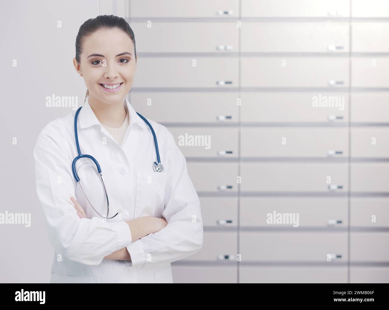 Professional female pharmacist posing in front on pharmacy drawers ...