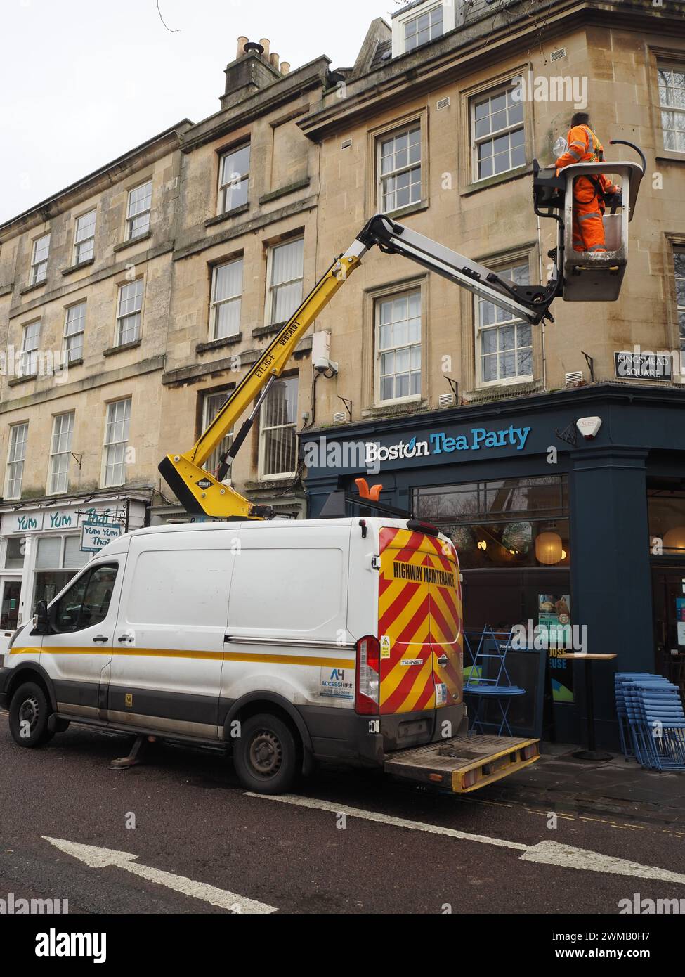 Workers using van-mounted cherry picker to install new wall mounted ...