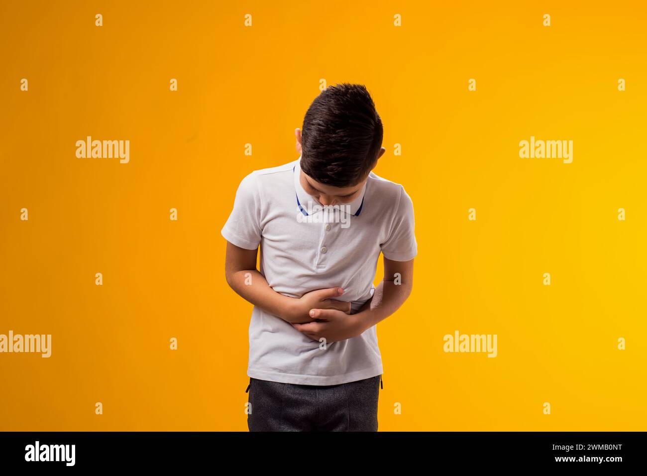 Stomachache. Kid boy suffering from abdominal pain touching aching ...