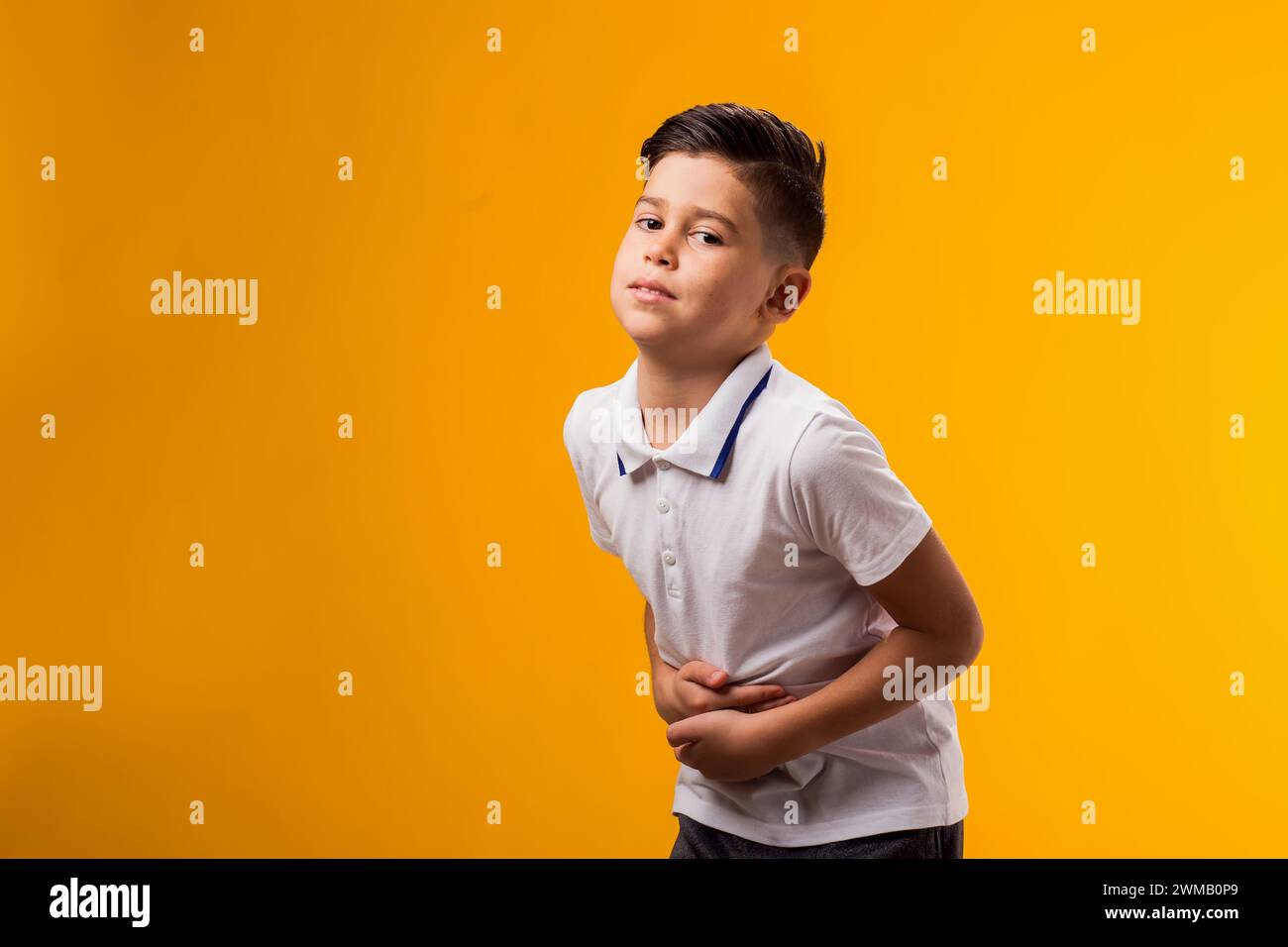 Stomachache. Kid boy suffering from abdominal pain touching aching ...