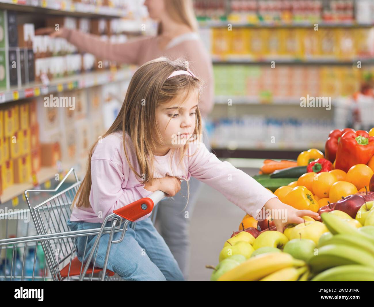 Daughter sitting supermarket trolley lovely hi-res stock photography ...
