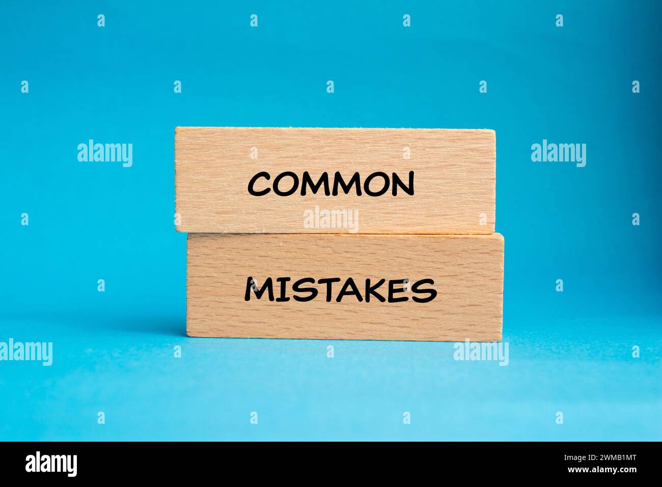 Common mistakes words written on wooden blocks with blue background ...