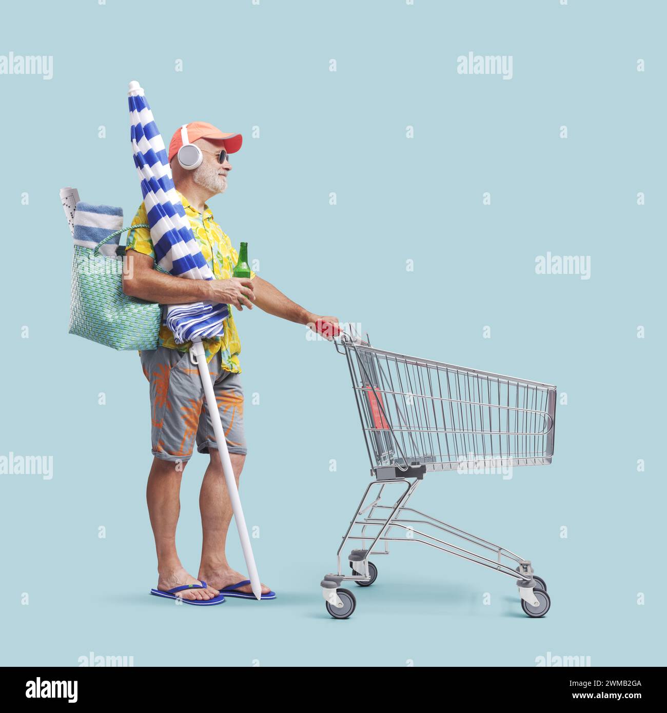 Funny senior tourist pushing a shopping cart and carrying beach ...