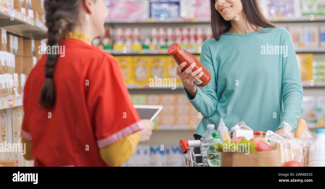 Customer and saleswoman grocery store hi-res stock photography and ...