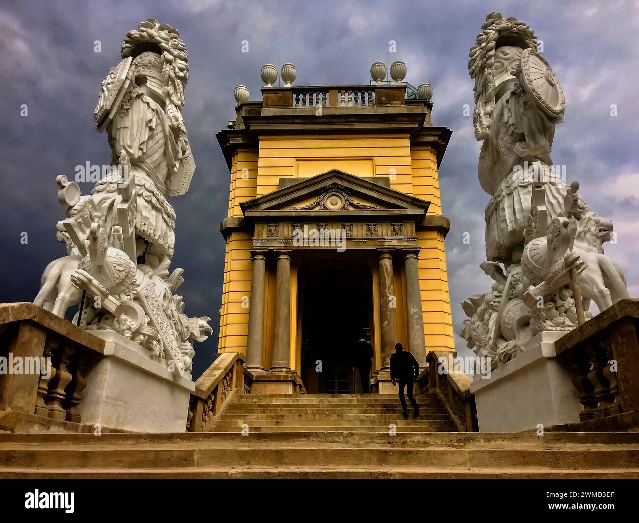 The image shows a person ascending steps towards a neoclassical ...