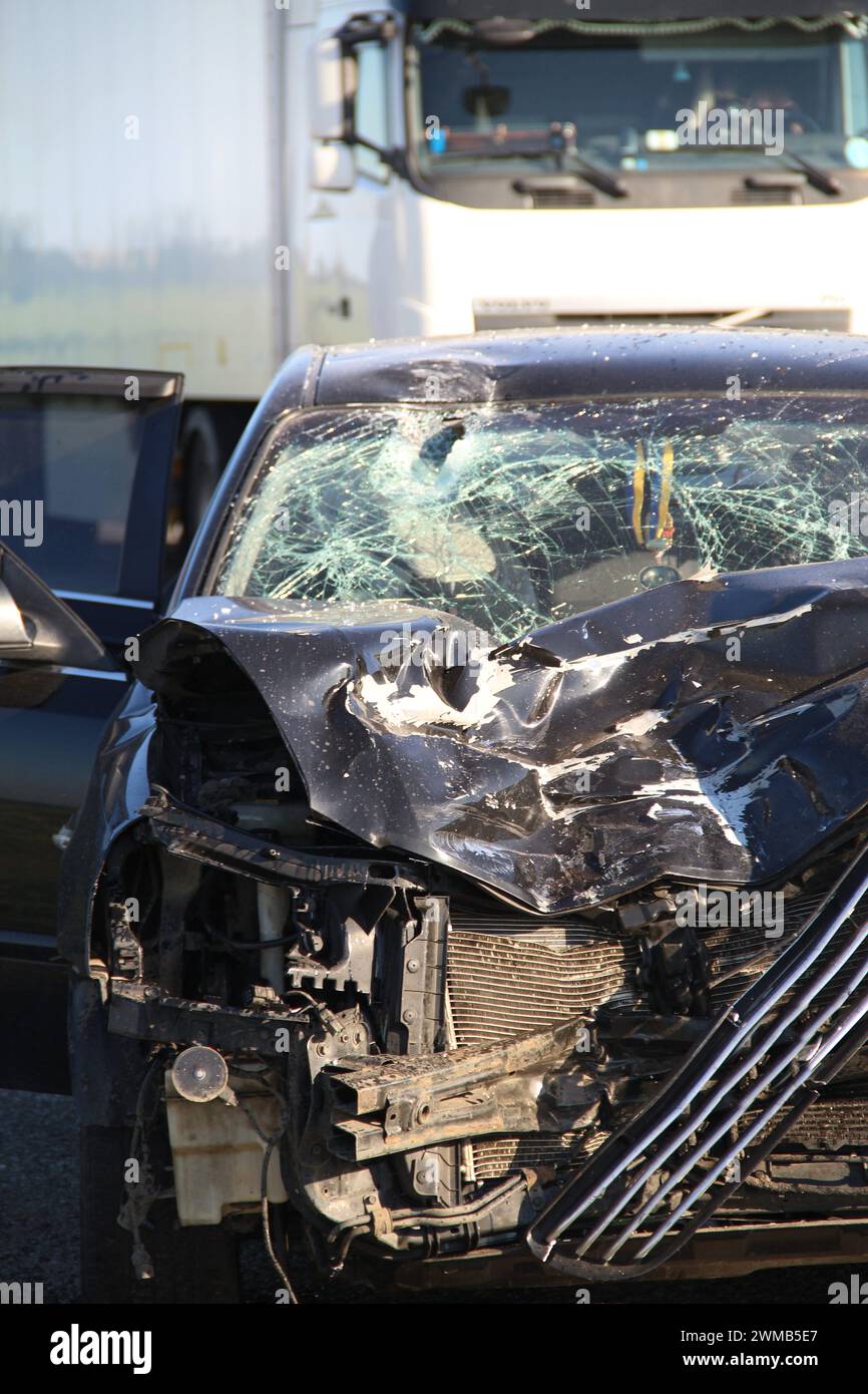 Broken engine compartment and mangled car engine after a head-on collision at high speed Stock ...