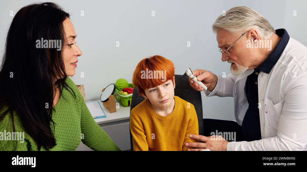 Handsome boy with his mother during hearing test, audiologist with ...