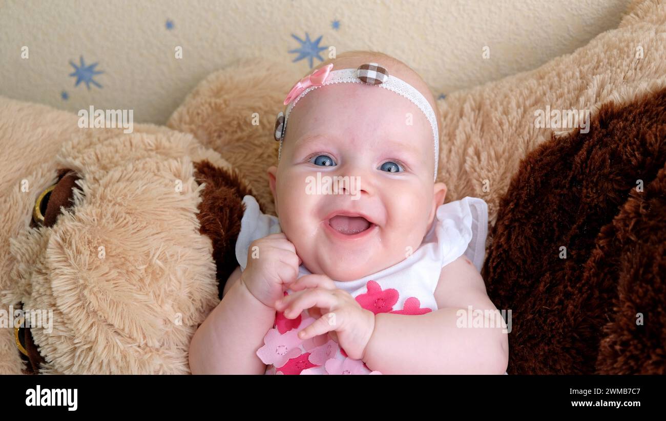 Baby girl with funny smile Stock Photo - Alamy