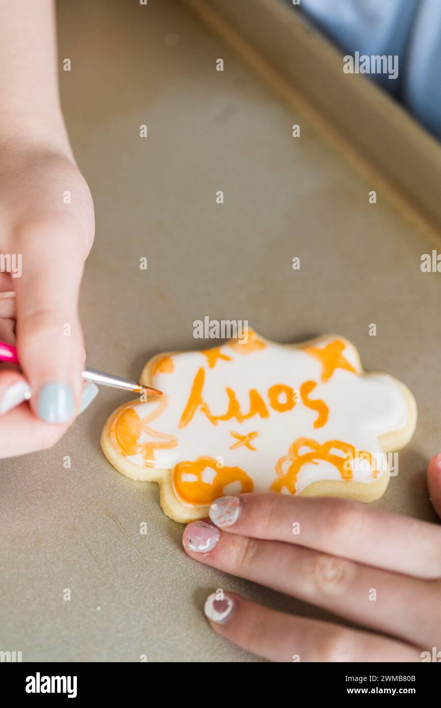 Little Girl Spells 'Sorry' on Iced Sugar Cookies Stock Photo - Alamy