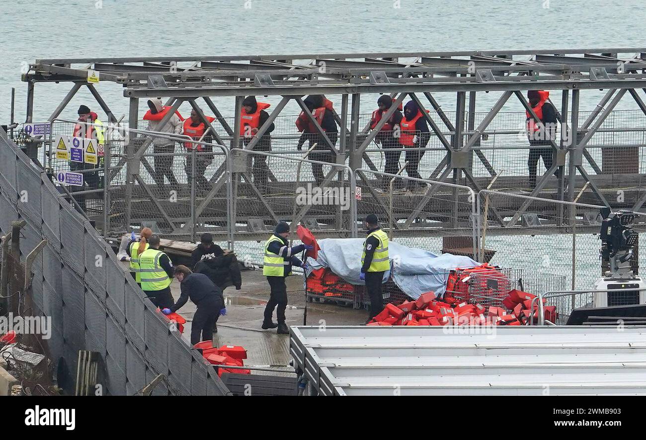 A group of people thought to be migrants are brought in to Dover, Kent ...
