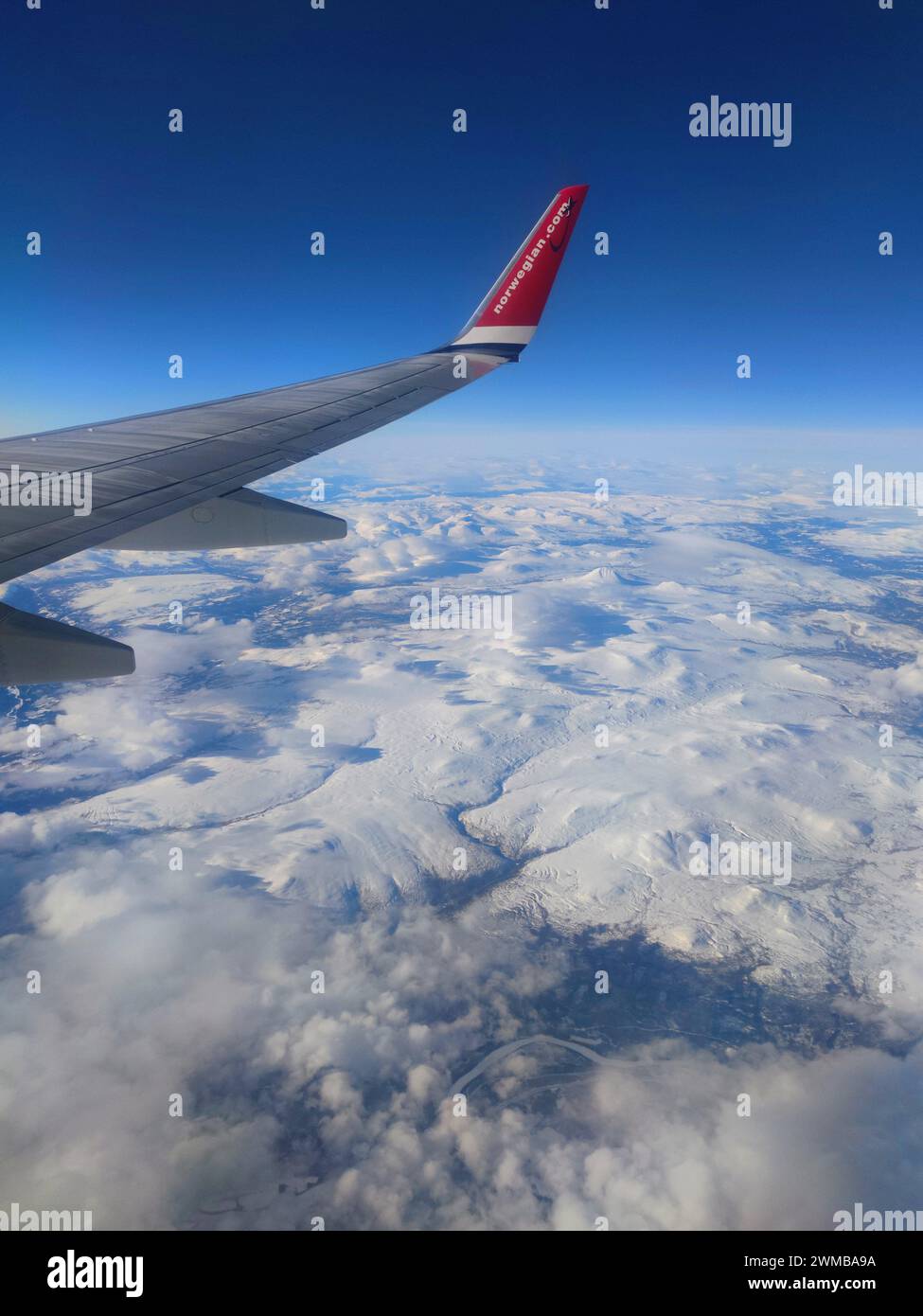 Aerial view from Norwegian Airlines aircraft of snow covered landscape ...