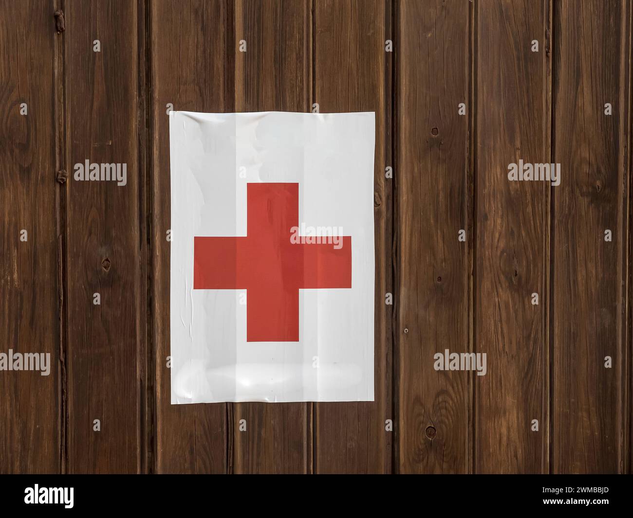 The image presents a simplistic yet powerful symbol, the red cross on a white background ...