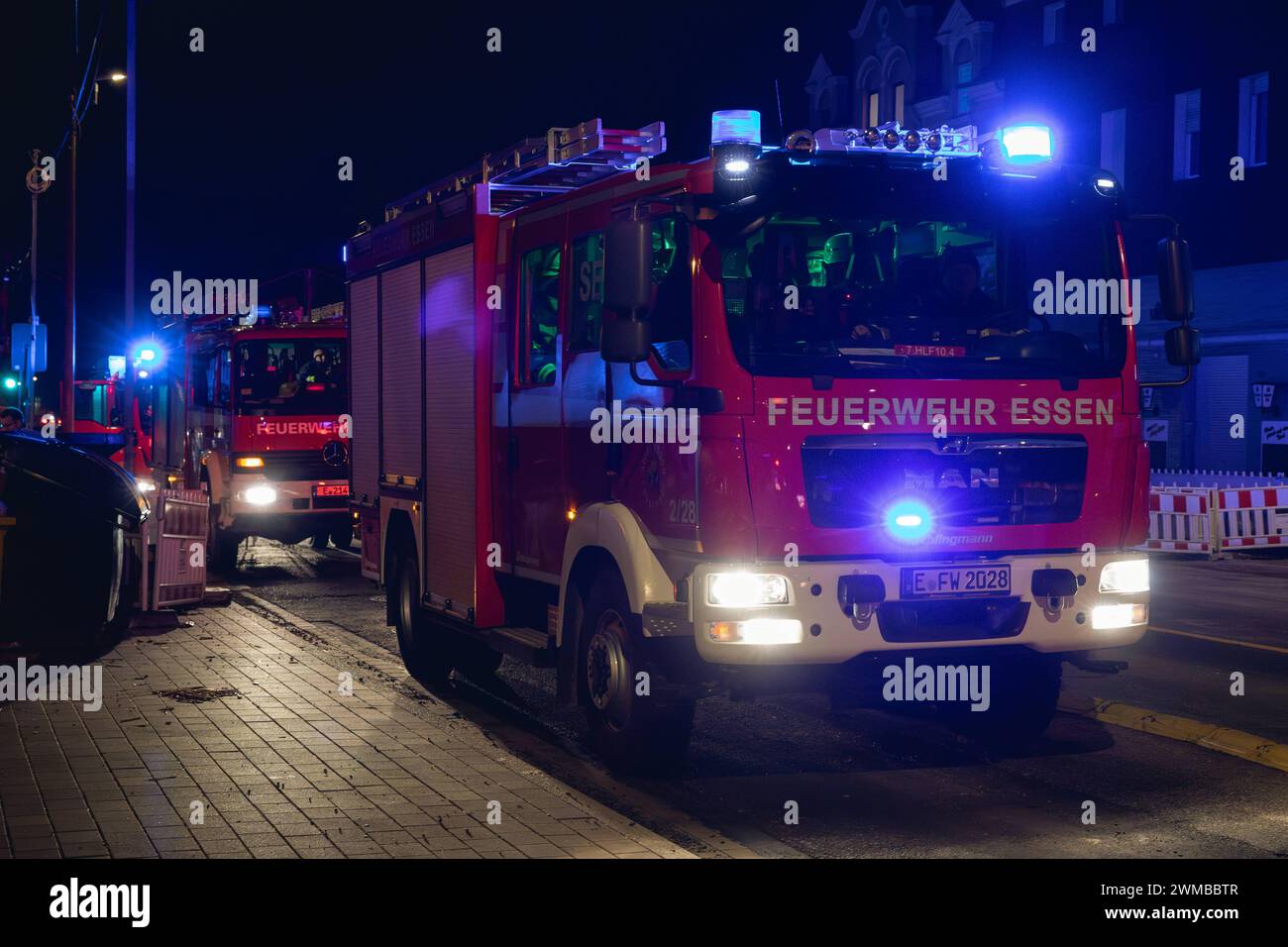 Feuerwehrfahrzeug bei einem Brandeinsatz mit Blaulicht. *** Fire engine ...