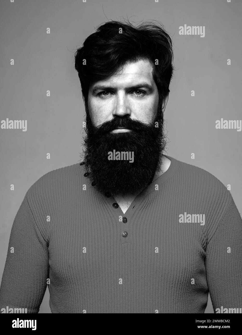 Serious bearded man portrait. Looks seriously, Isolated on gray Stock ...