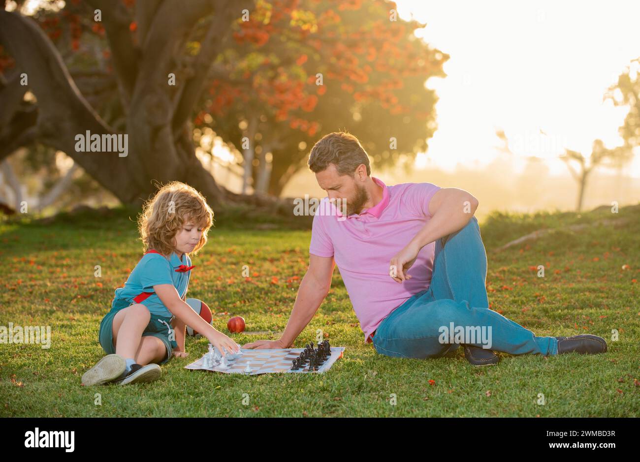 Father play chess with son. Thinking child while playing chess. Family ...