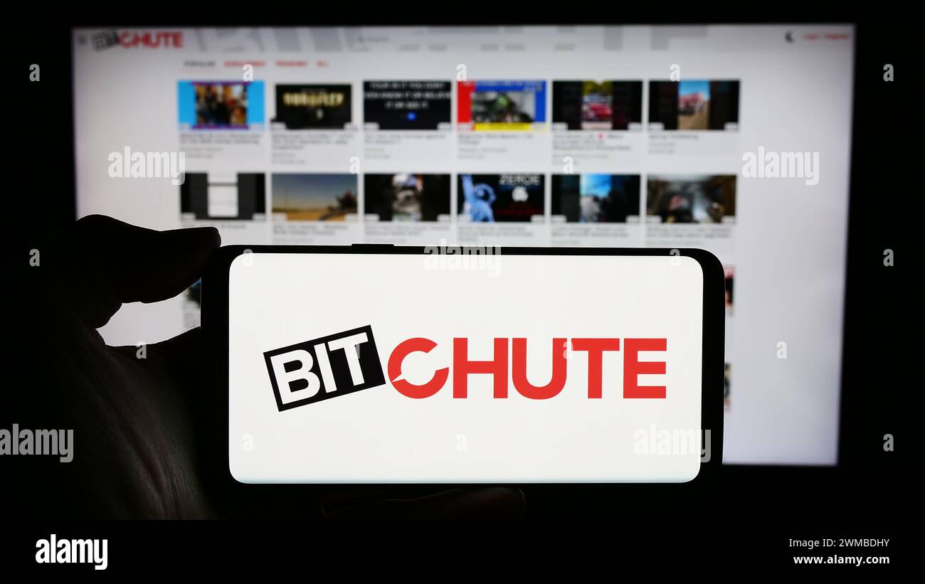Person holding cellphone with logo of video hosting company BitChute in ...