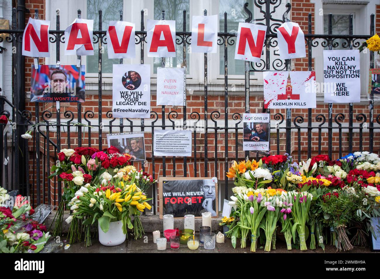 London, UK. 24th Feb, 2024. Flowers, candles and pictures are placed as ...