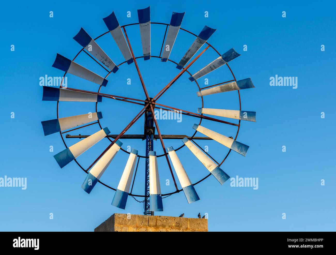 A close-up view of a modern windmill with steel blades in the interior ...