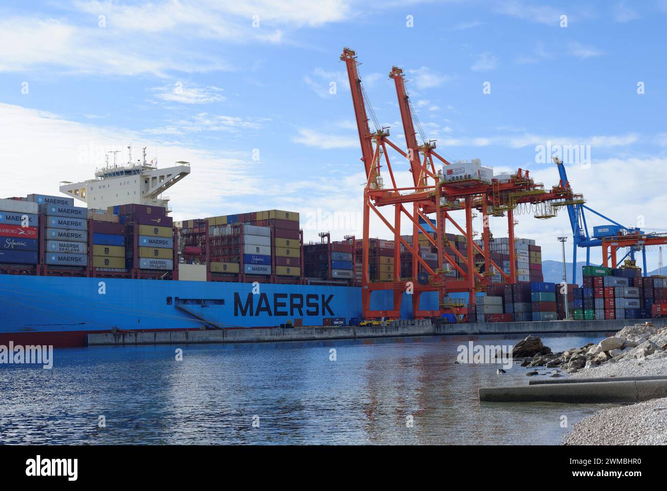 Cargo container ship in port ready for load or unload against the blue ...