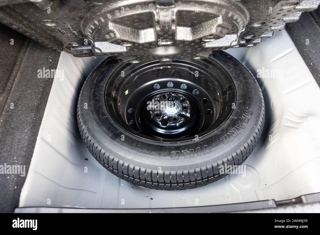 Temporary spare tire in the car boot for emergency use Stock Photo - Alamy