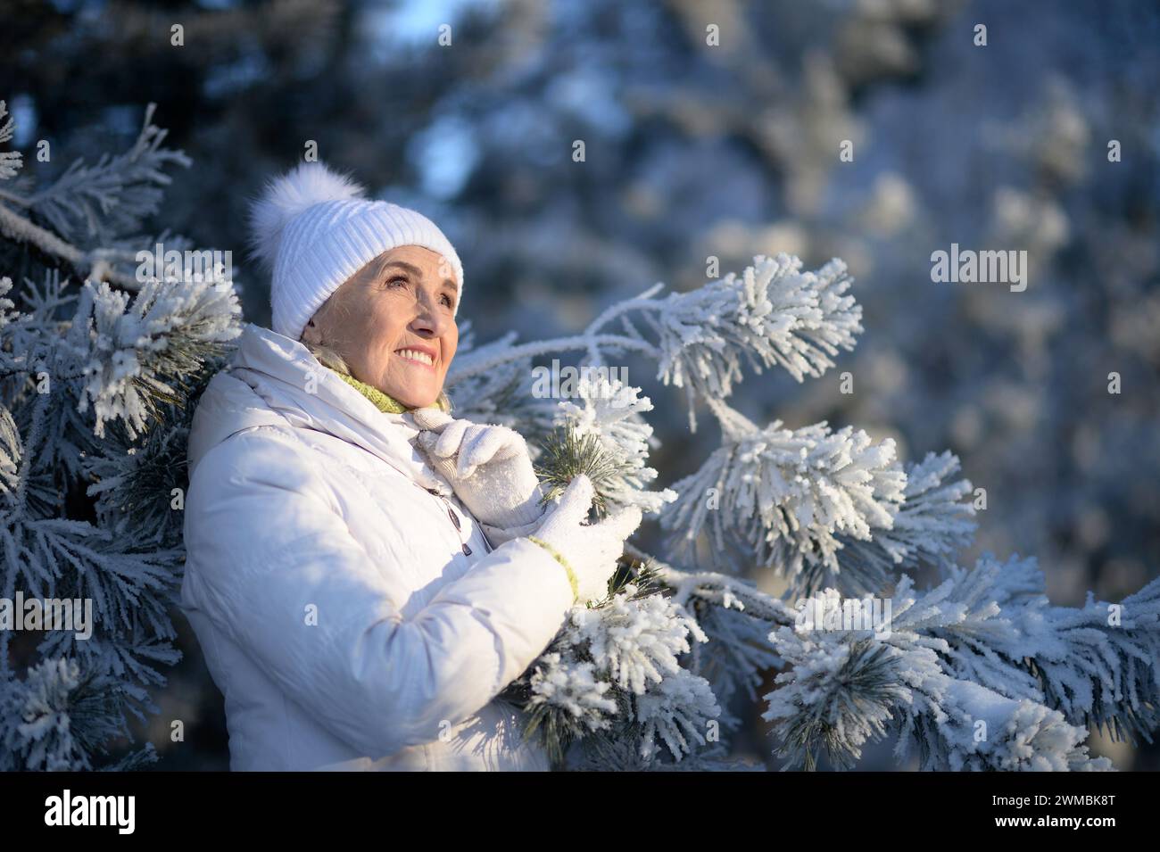 Happy old woman posing in the winter park Stock Photo - Alamy