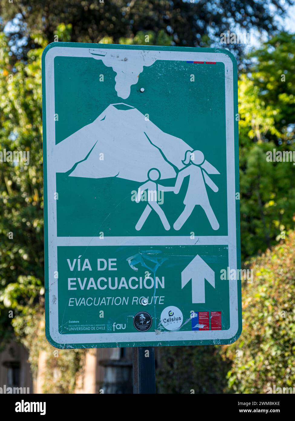 Signpost indicating evacuation route in case of a volcano eruption ...