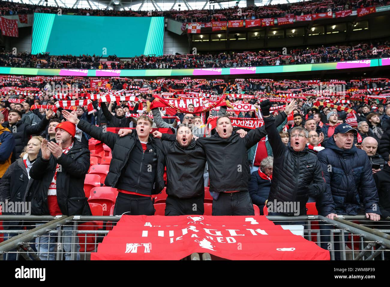 Liverpool fans sing You'll Never Walk Alone as they hold their scarfs ...