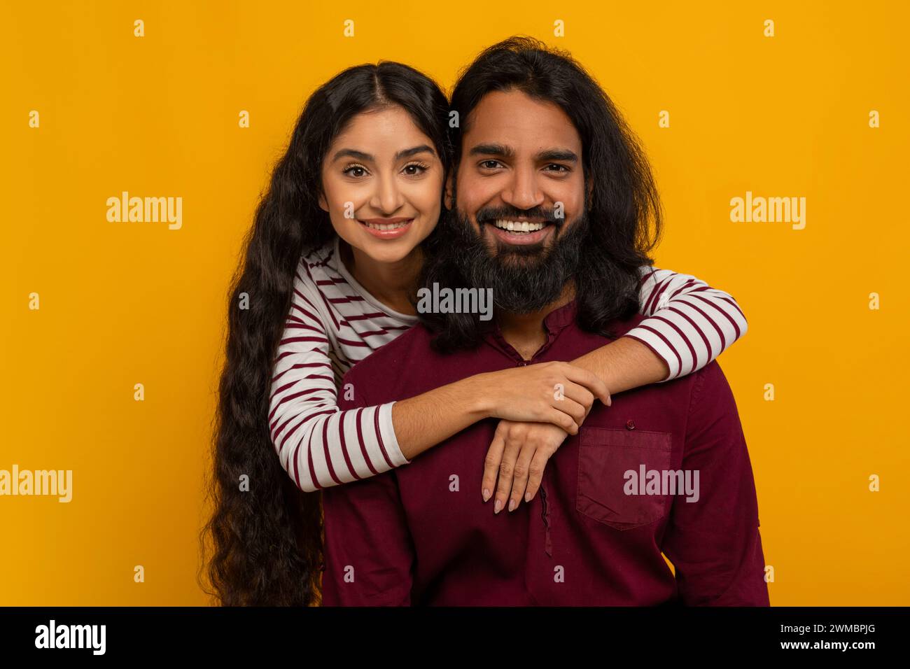 Pretty young indian woman hugging her husband from behind Stock Photo ...