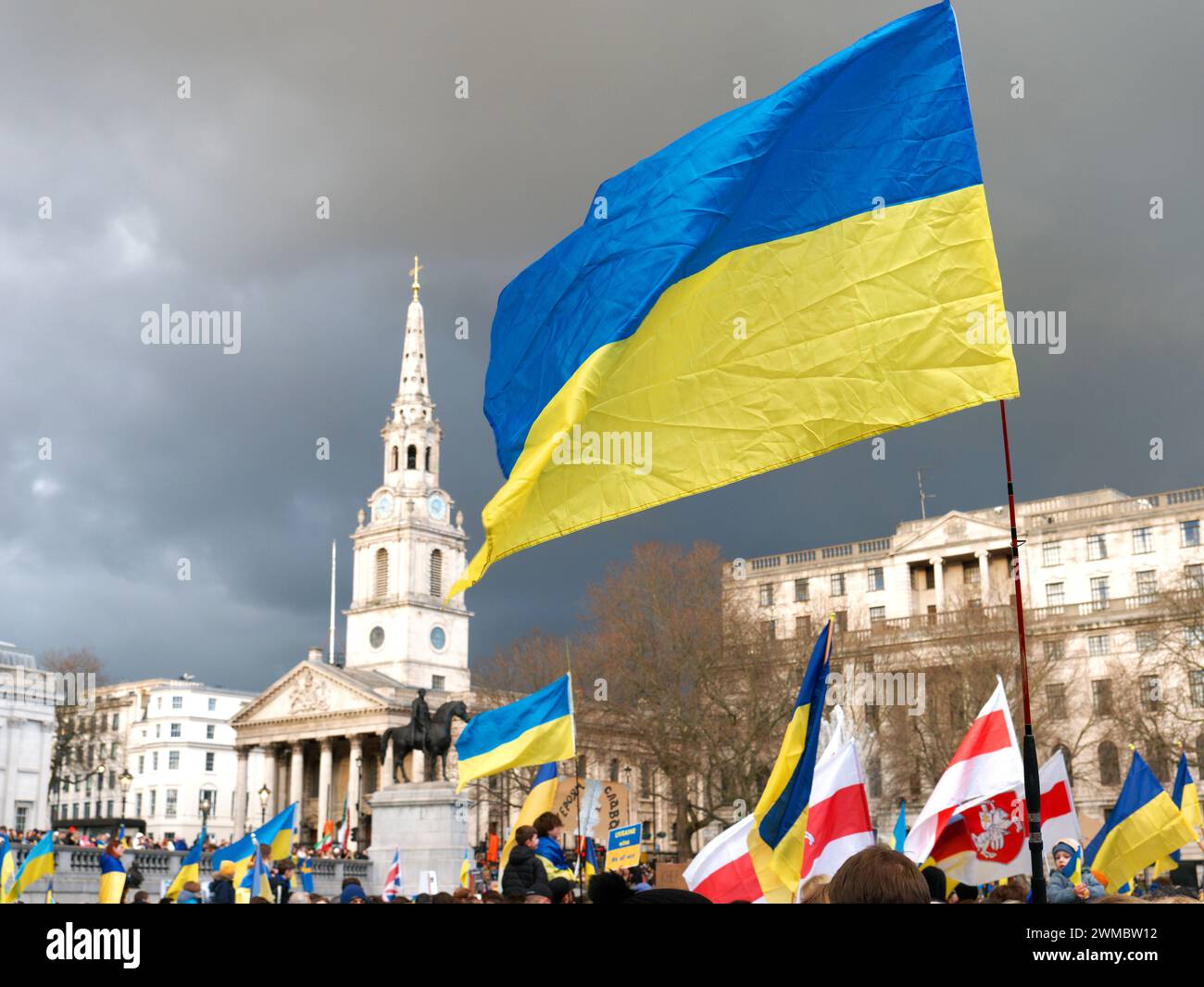 View of a Ukrainian flag flying at a rally in Trafalgar Square London ...