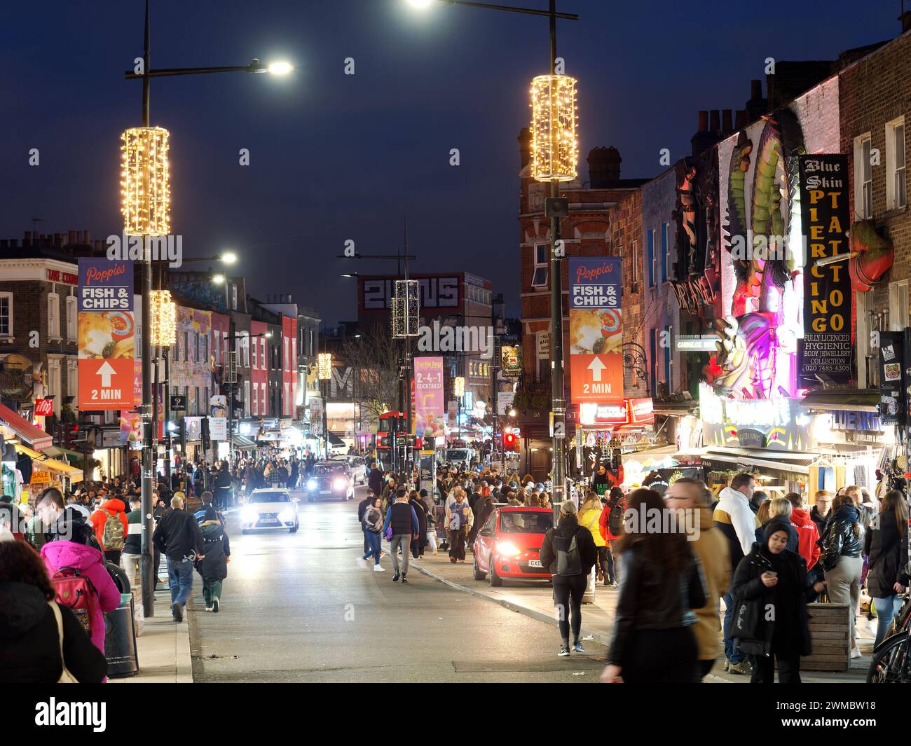 View of Camden High Street at night still busy with shoppers and ...