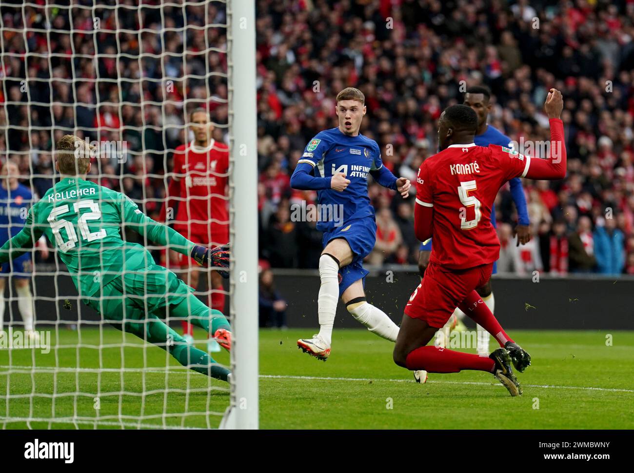 Liverpool goalkeeper Caoimhin Kelleher (left) saves a shot from Chelsea ...