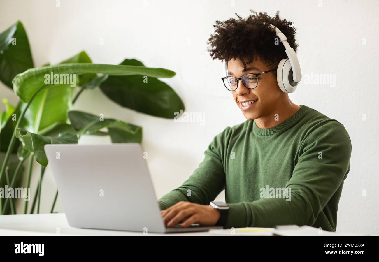 Handsome african american guy developer working at cozy office Stock ...