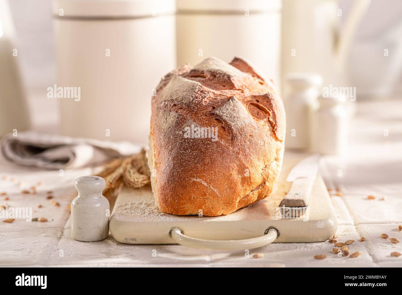 Rectangular loaf of rye bread baked in a rustic bright kitchen. Rustic ...
